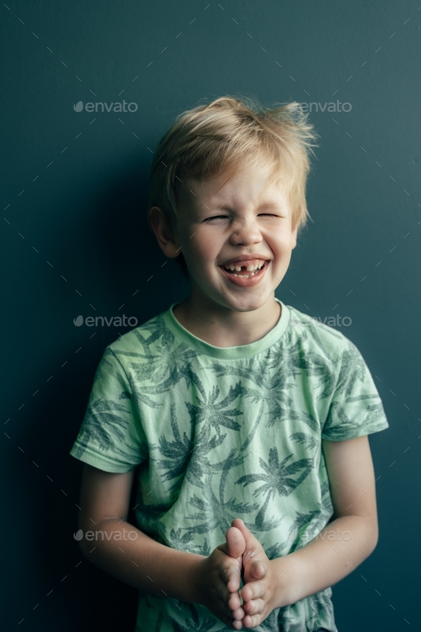 Cheerful boy child laughing toothless smile Stock Photo by titovailona