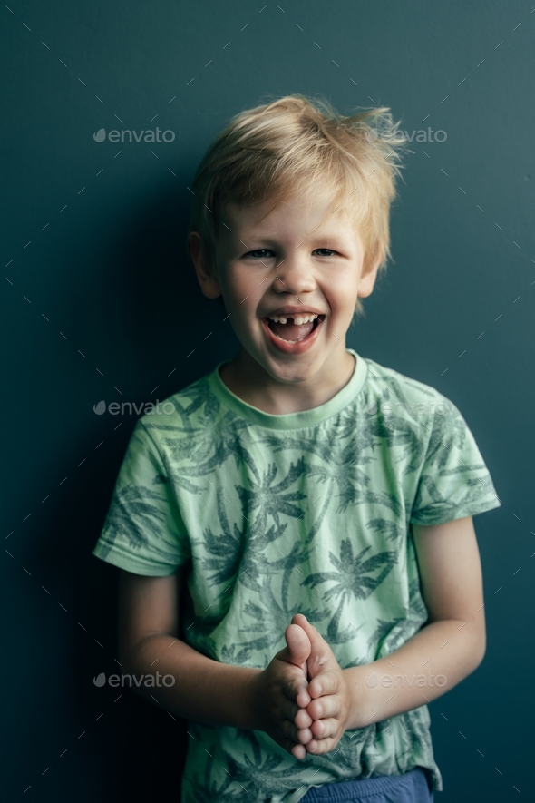 Cheerful boy child laughing toothless smile Stock Photo by titovailona