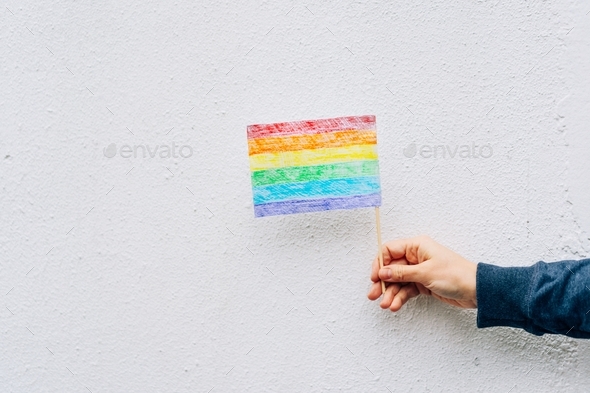 LGBTQ paper flag in the hand of an unrecognizable person Stock Photo by ...
