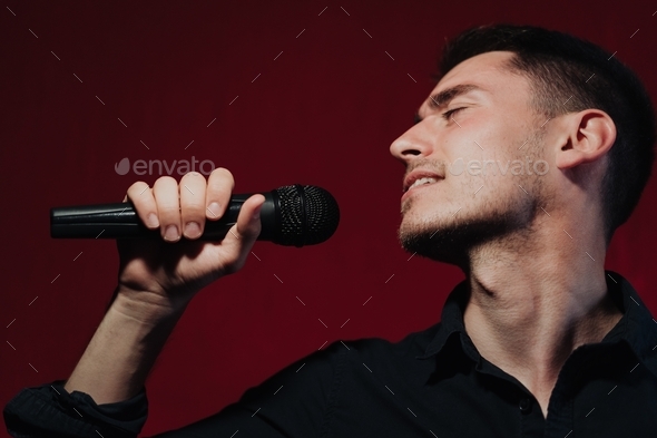 Close up photo of guy singing a song in an authentic studio during ...