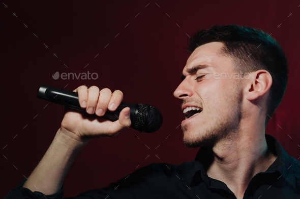 Close up photo of guy singing a song in an authentic studio during ...