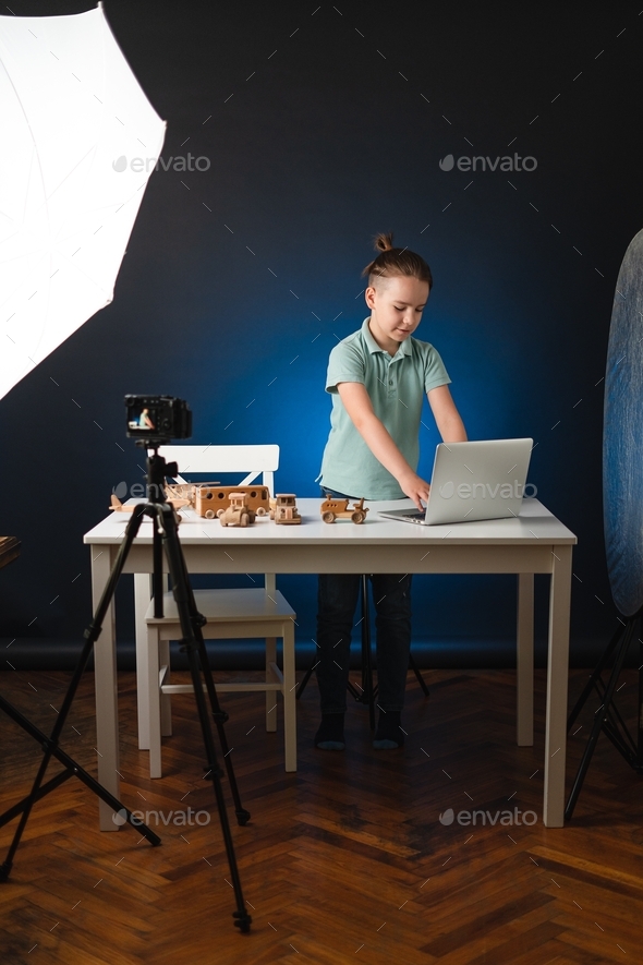 Young guy streaming for his fans. Boy explaining in front of camera ...