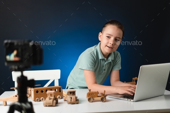 Young guy streaming for his fans. Boy explaining in front of camera ...