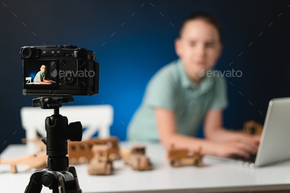 Young guy streaming for his fans. Boy explaining in front of camera ...