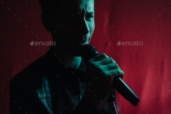 Close up photo of guy singing a song in an authentic studio during ...