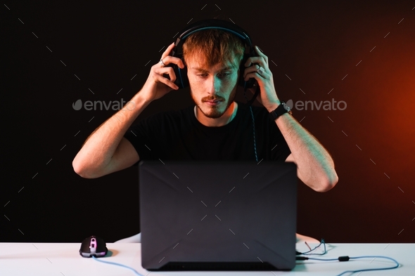 Gamer getting ready for an online gaming tour. Generation Z. Guy using ...