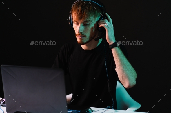 Gamer getting ready for an online gaming tour. Generation Z. Guy using ...