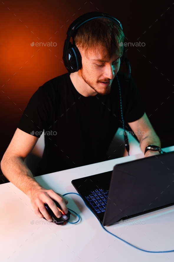 Gamer getting ready for an online gaming tour. Generation Z. Guy using ...