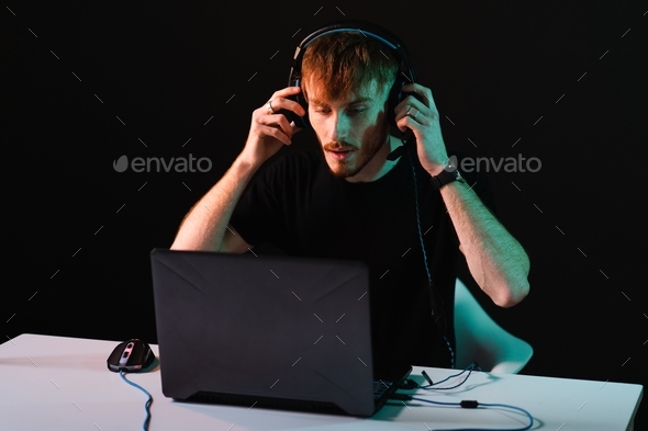 Gamer getting ready for an online gaming tour. Generation Z. Guy using ...