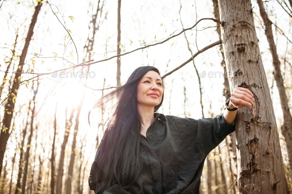 Forest conservation concept. Woman walking in forest at Sunrise. Beaty ...