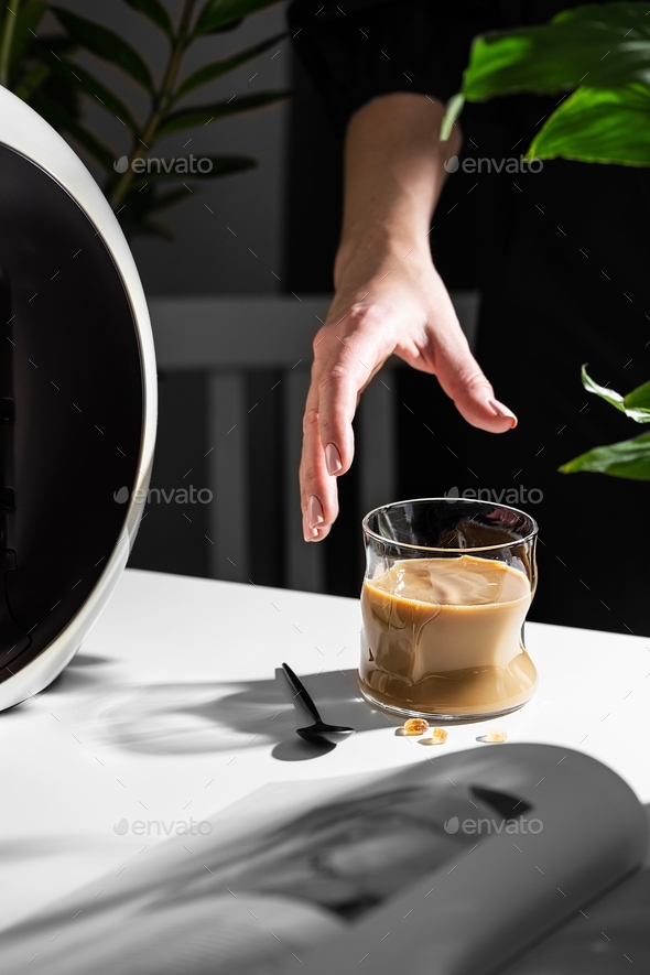 Woman’s hand reaching for a cup of coffee Stock Photo by Tati_honey