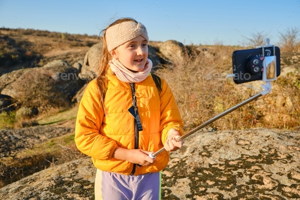 child vlogger filming daily video diary outdoors. kid creating social ...