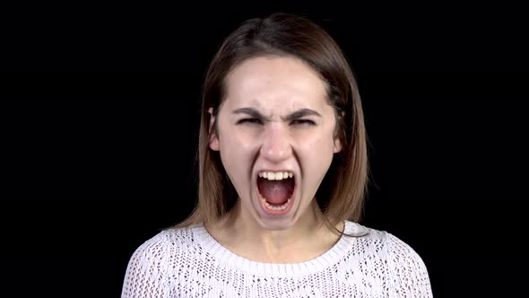 A Young Woman Shows Emotions of Anger on Her Face. Woman Screams in ...