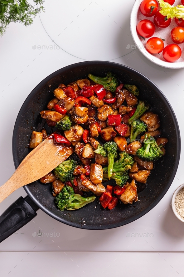Pan with fried teriyaki chicken and vegetables Stock Photo by Tati_honey