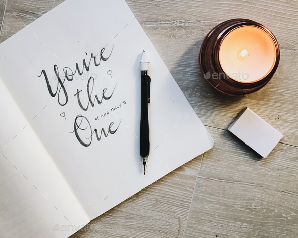 Calligraphy and scripted writing in a notebook with a mechanical pencil ...