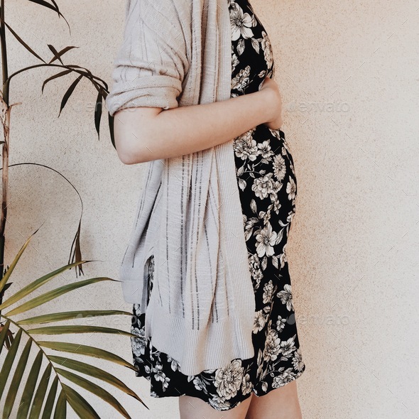 Young woman holding her baby belly in her second trimester. Stock Photo ...