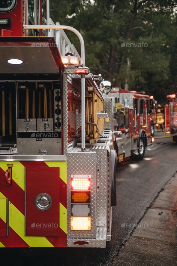 Fire trucks line the road in a neighborhood where a home caught on fire ...