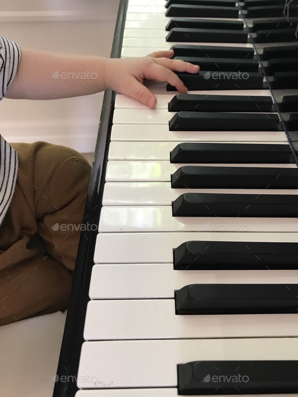 Child's hand on piano keys Stock Photo by debbalba | PhotoDune