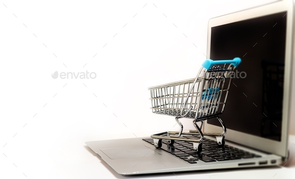Shopping cart on laptop computer Stock Photo by LittleIvan | PhotoDune