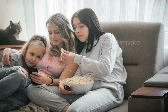 meeting girls in a warm home atmosphere with popcorn Stock Photo by olgar23