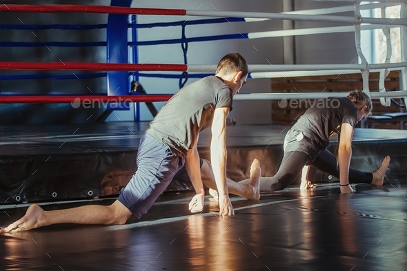 Teen Boxers Do Stretches Before Main Workout Stock Photo by olgar23