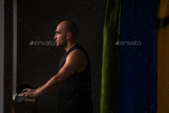 male athlete boxer looks tiredly out the window after the fight Stock ...
