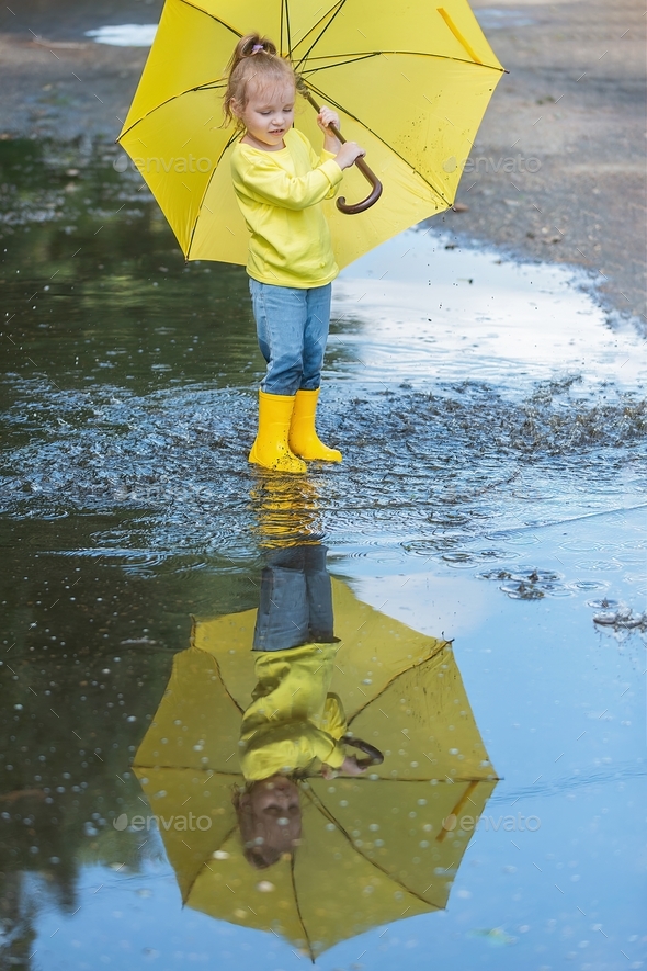 little girl on an active and fun walk through the puddles Stock Photo ...