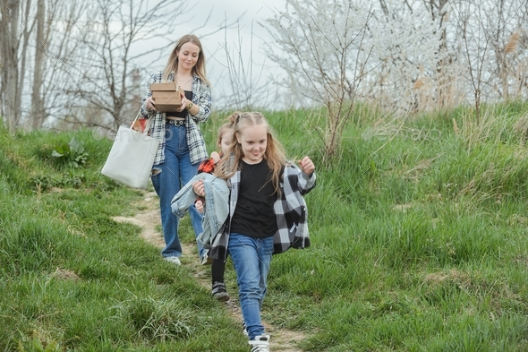 Happy active family goes on a picnic in the warm season, early spring ...