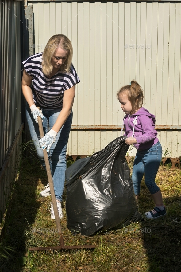 adults and children do household chores together, clean leaves and ...