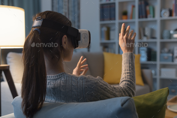 Woman relaxing on the sofa and interacting with virtual reality Stock ...