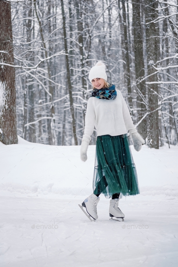 Ice skating in winter forest. Young caucasian woman walking on snowy ...