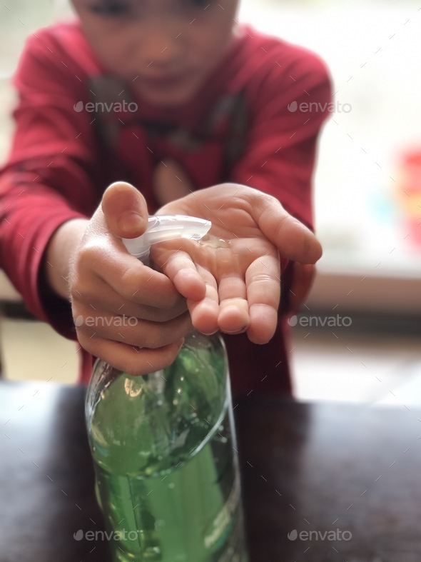Child putting hand sanitizer on his hands focus on hands Stock Photo by ...