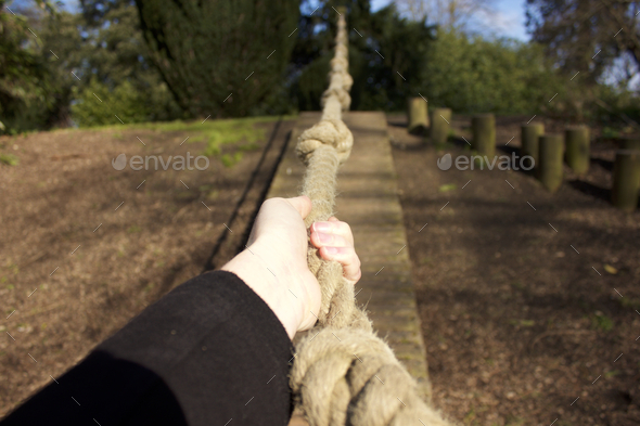 Woman’s hand holding onto and pulling rope in tug of war Stock Photo by ...