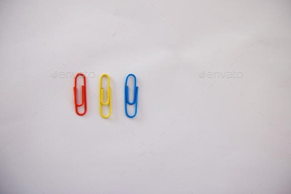 Colorful minimalism red yellow blue paper clips in row on white ...