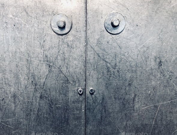 Silver metal wall with bolts and screws from monolith type structure ...