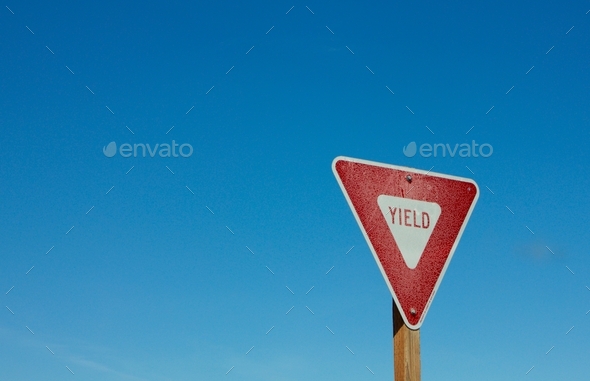 Yield sign against blue sky background room for copy Stock Photo by ...