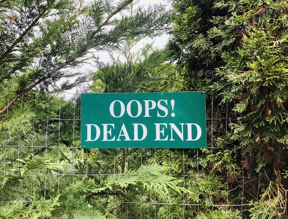 Oops dead end sign in green hedge of hedge maze Stock Photo by reinasmyth