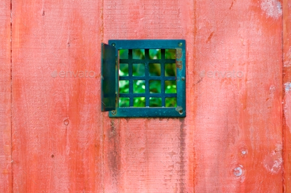 Red painted door with small square peephole Stock Photo by reinasmyth