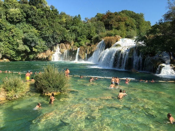 People in waterfall river pool during summer Stock Photo by reinasmyth