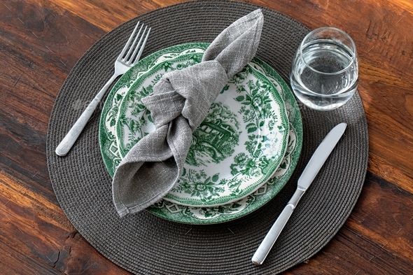 Table setting. Decorated table. Glass of water. Dinner Bowls and Plates ...