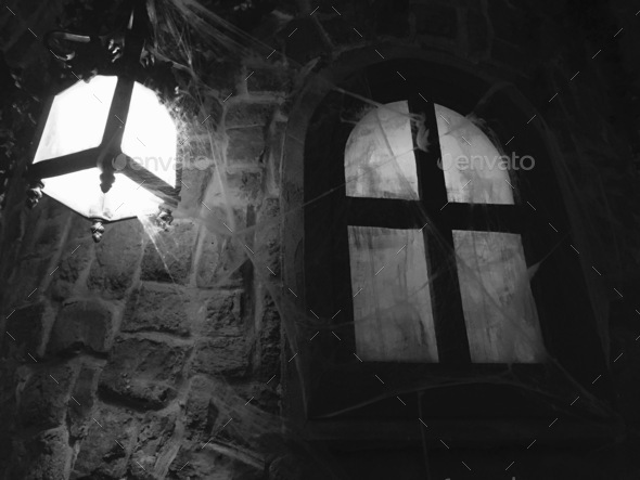 Spooky window with lamp and spider web Stock Photo by savinmadeleine