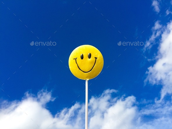 Smiley emoticon on a stick with blue sky in the background Stock Photo ...