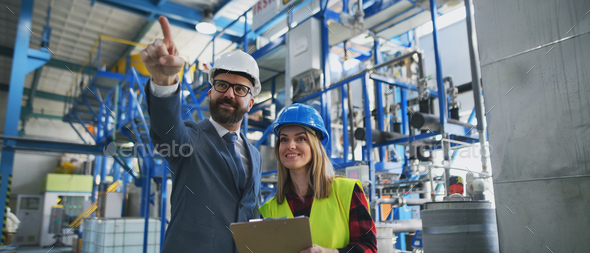 Engineering manager and mechanic worker doing routine check up in ...