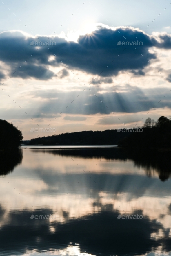 Scenic View Of Calm Lake At Sunset. River weather sun rays. Clouds ...