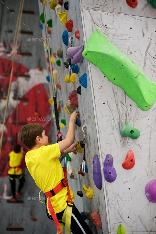 Kids rock climbing in climbing gym Stock Photo by Marinabars_photo