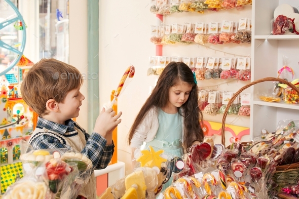 Happy children in a candy store Stock Photo by gilitukha | PhotoDune