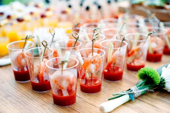 Snack cocktails with tomato juice and shrimps. Catering table for party ...