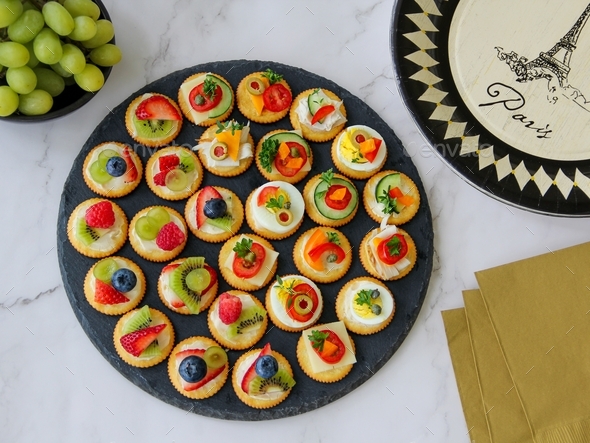 Colorful appetizers overhead flat lay on marble counter decorated for ...