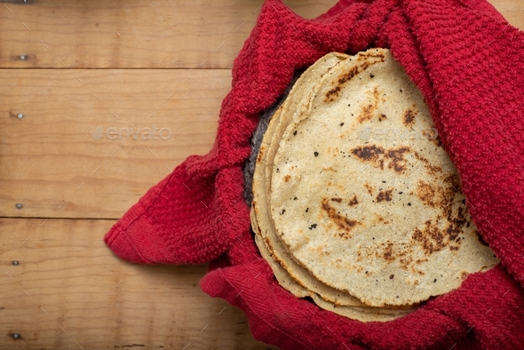 Handmade tortillas wrapped in red cloth. Stock Photo by sandorfotografia