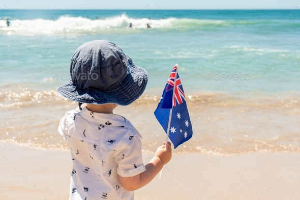 Little boy with Australian flag near the ocean. Australia Day concept ...